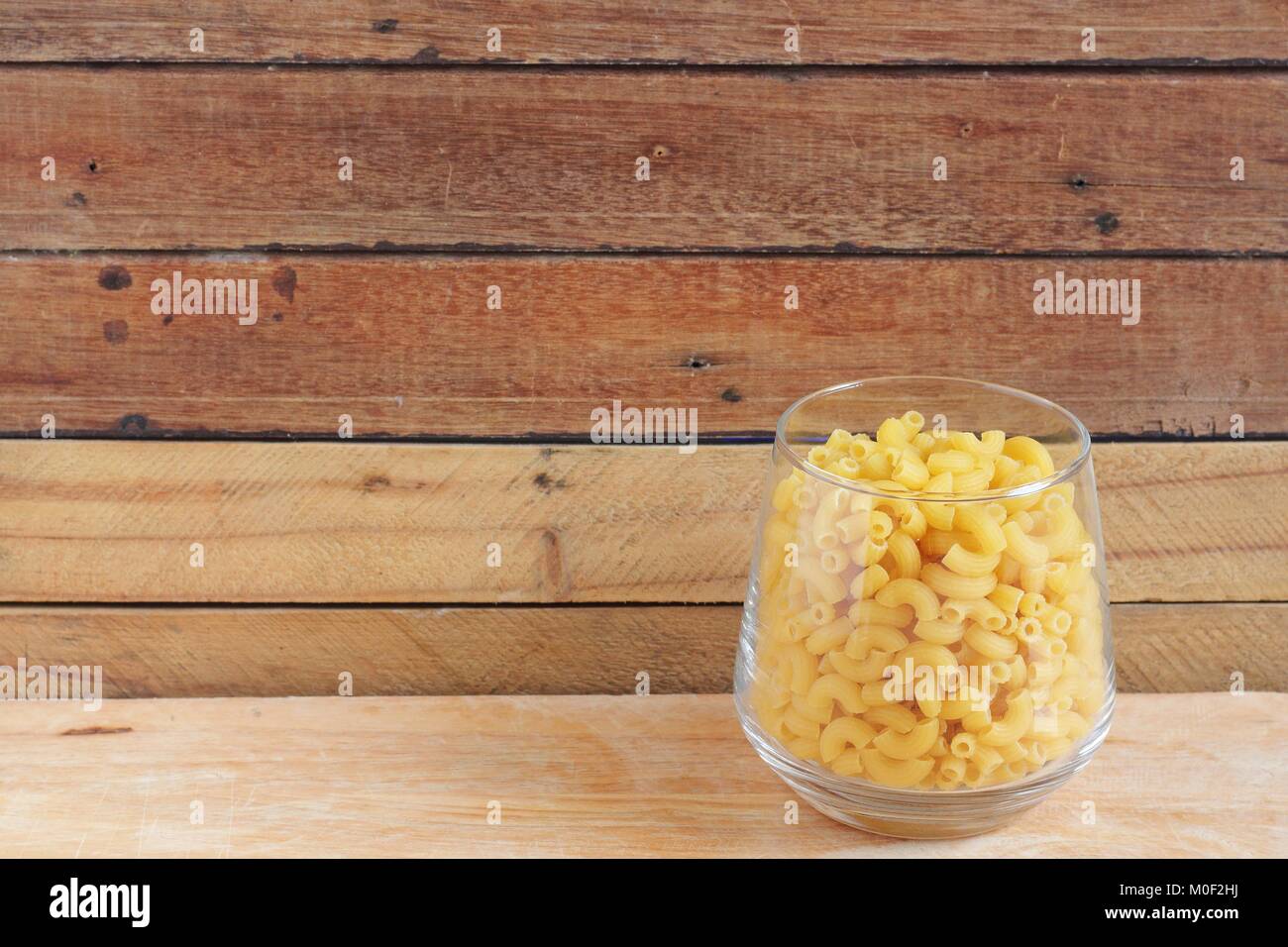 Italian Macaroni Pasta on wood background Stock Photo - Alamy
