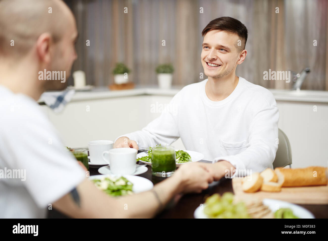 Gay couple eating breakfast home hi-res stock photography and images ...