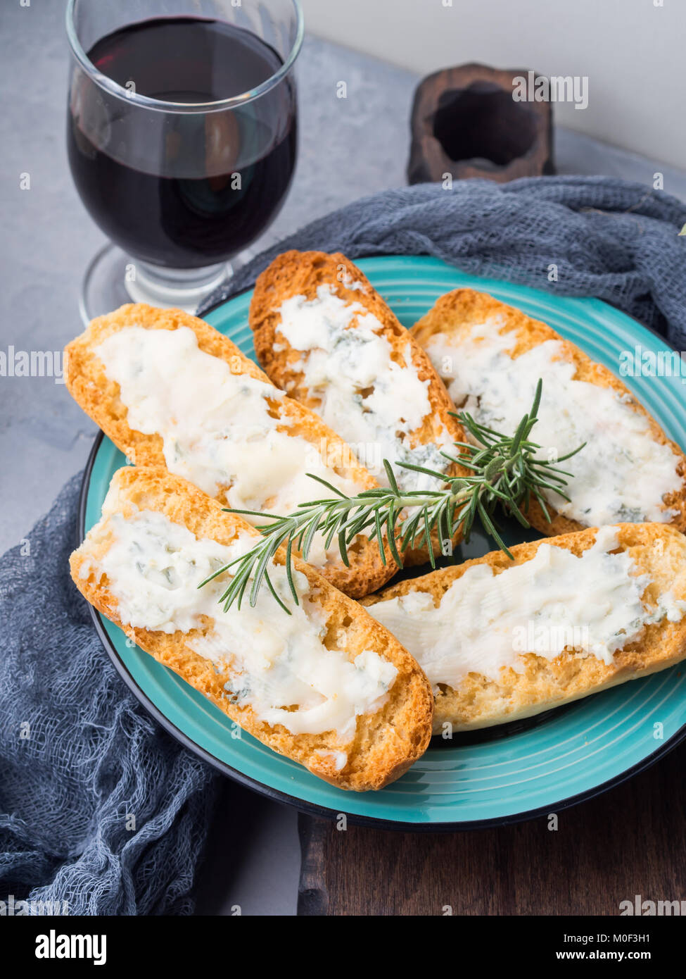 Italian toasts with gorgonzola cheese on rustic background with wine ...