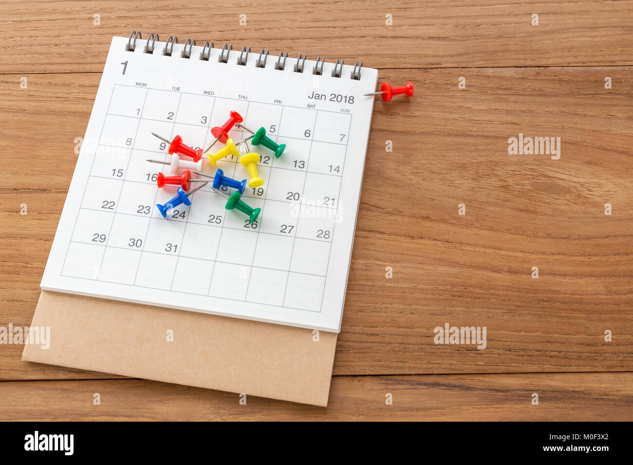 Calendar with pins on wooden table background Stock Photo - Alamy