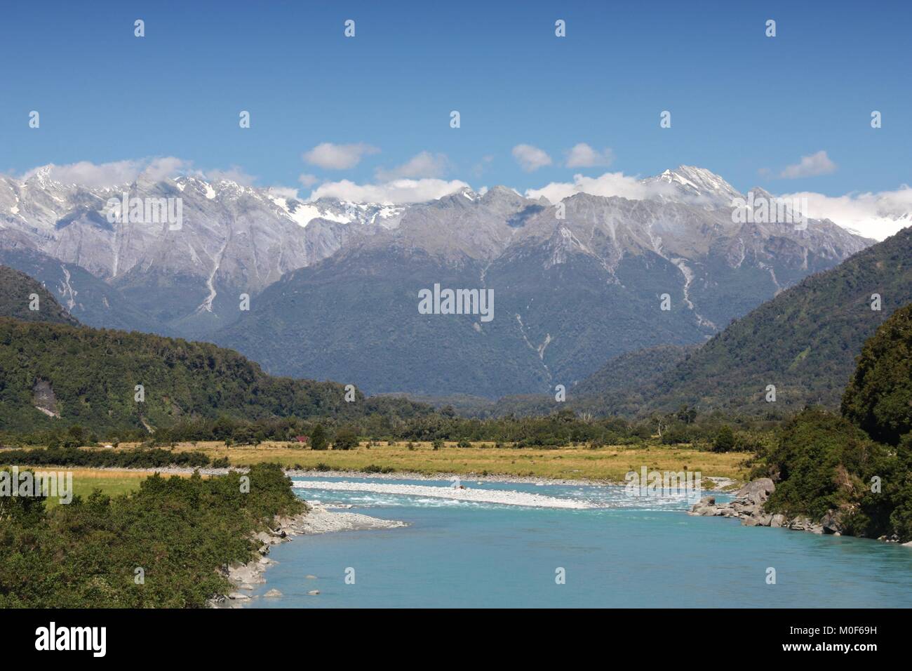 New Zealand landscape. Whataroa River and Southern Alps mountain range ...