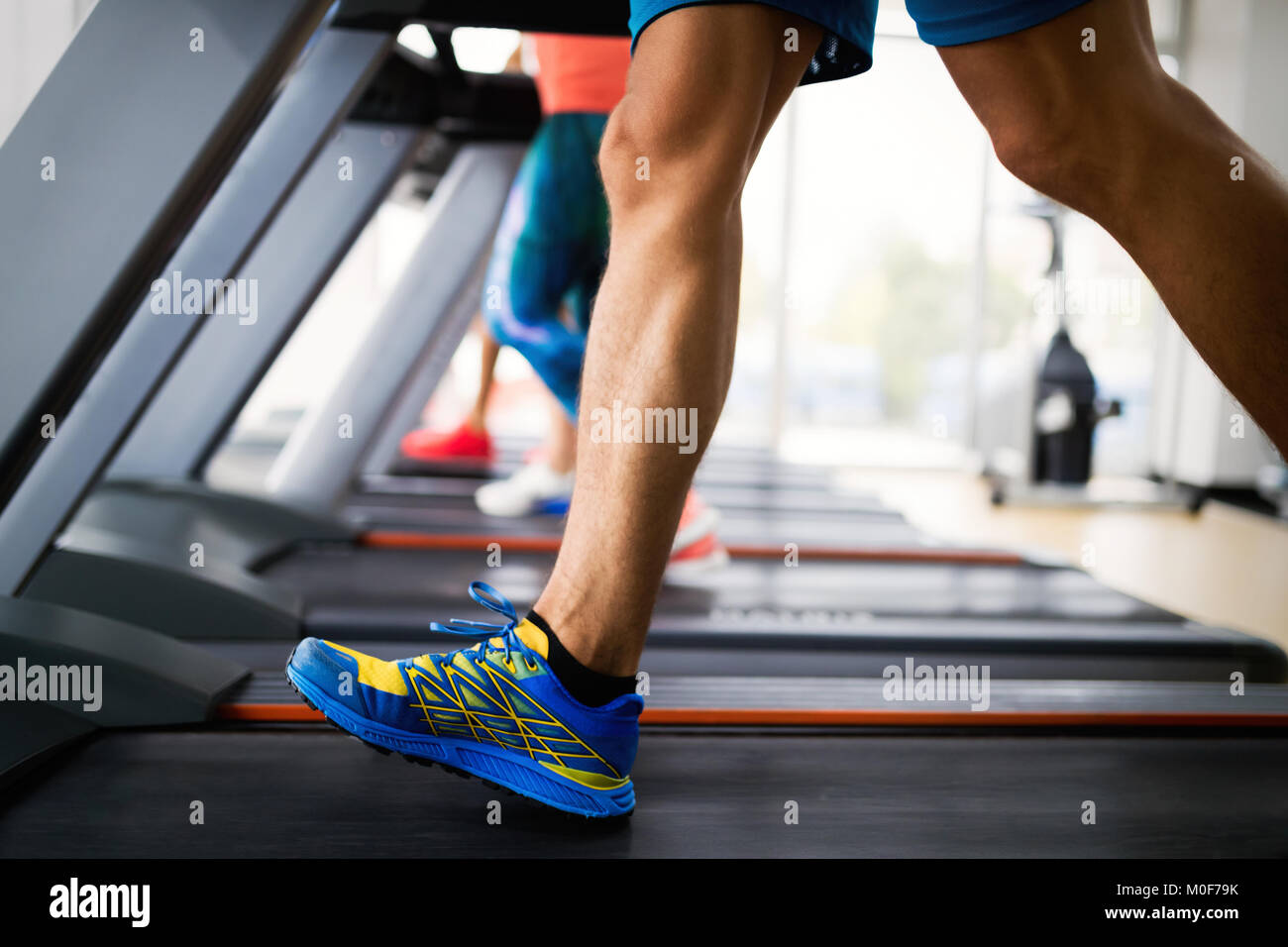 Picture of people running on treadmill in gym Stock Photo - Alamy