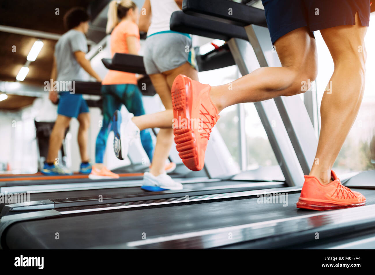 Picture of people running on treadmill in gym Stock Photo - Alamy