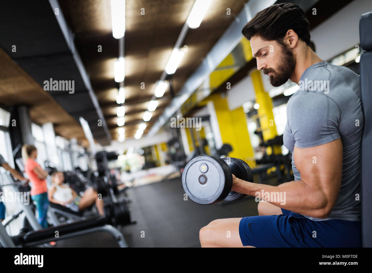 Determined male working out in gym Stock Photo - Alamy