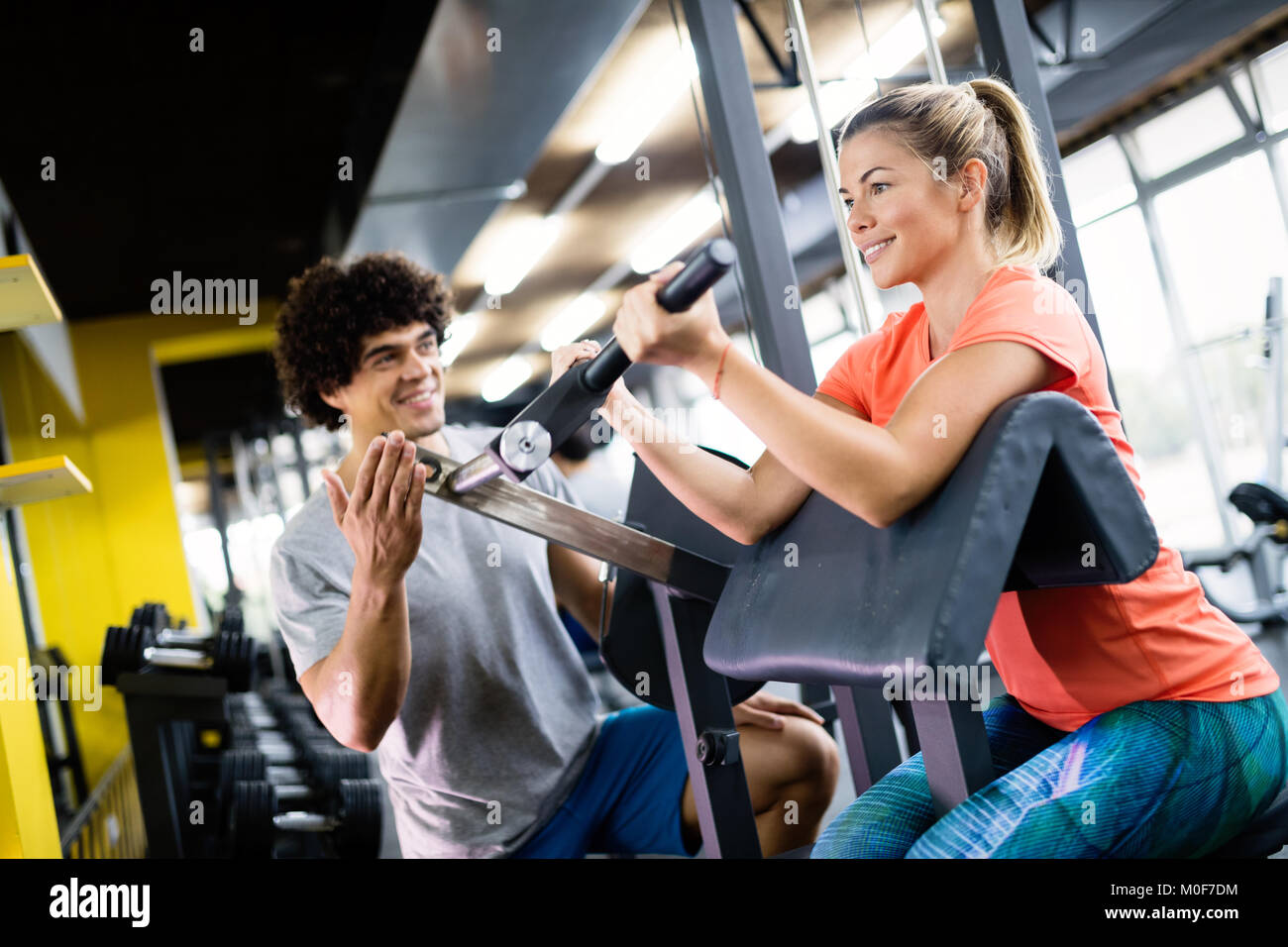 Personal trainer helping woman reach goals Stock Photo - Alamy