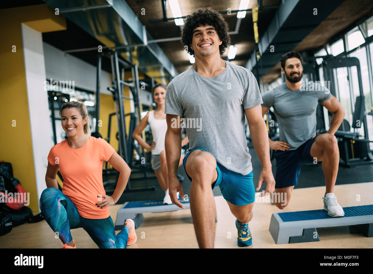 Picture of cheerful fitness team in gym Stock Photo - Alamy