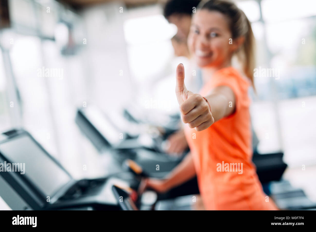 Pretty girl working out in a treadmill at the gym Stock Photo - Alamy