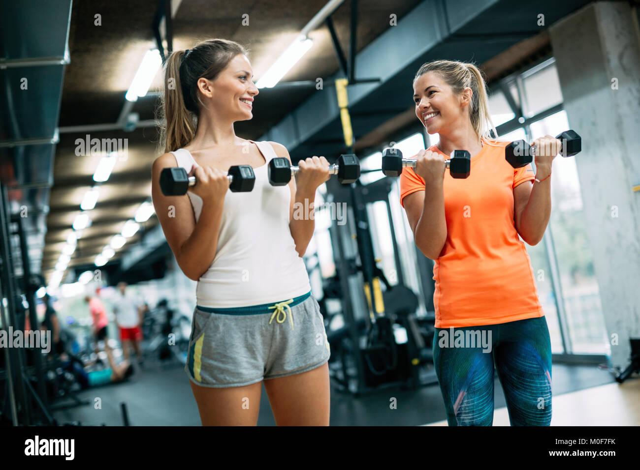 Beautiful women working out in gym together Stock Photo - Alamy