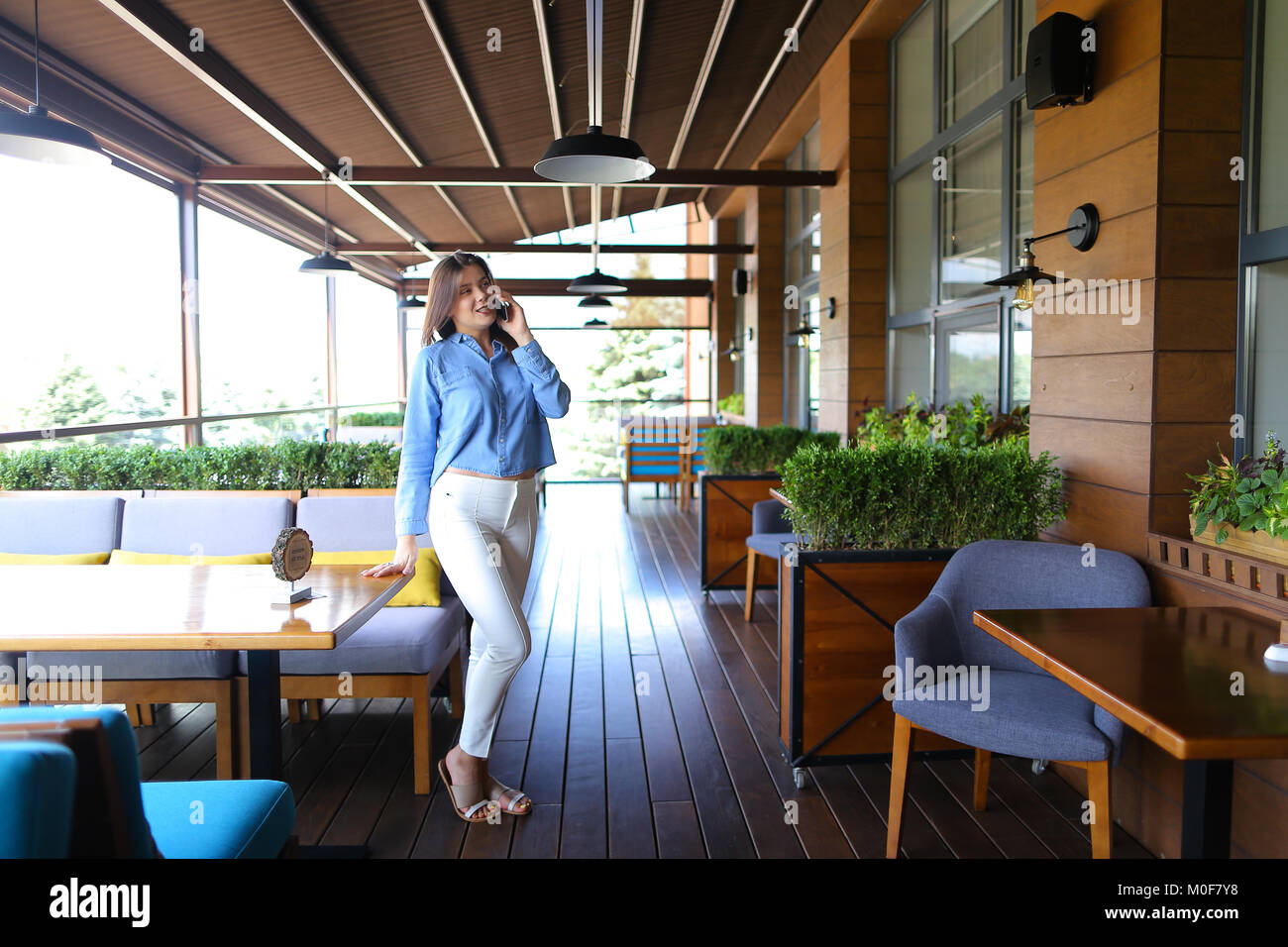 Beautiful female model speaking with photographer by smartphone Stock ...