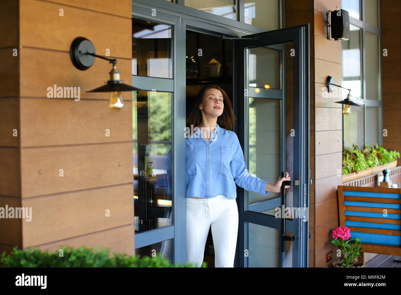 Cheerful woman leaving restaurant, talking by smartphone and loo Stock ...