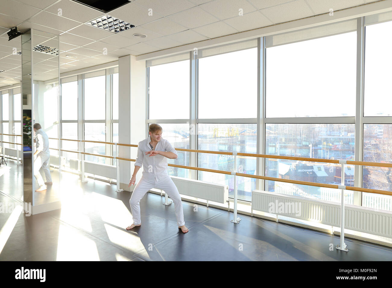 Blonde male person spotting in white suit Stock Photo - Alamy