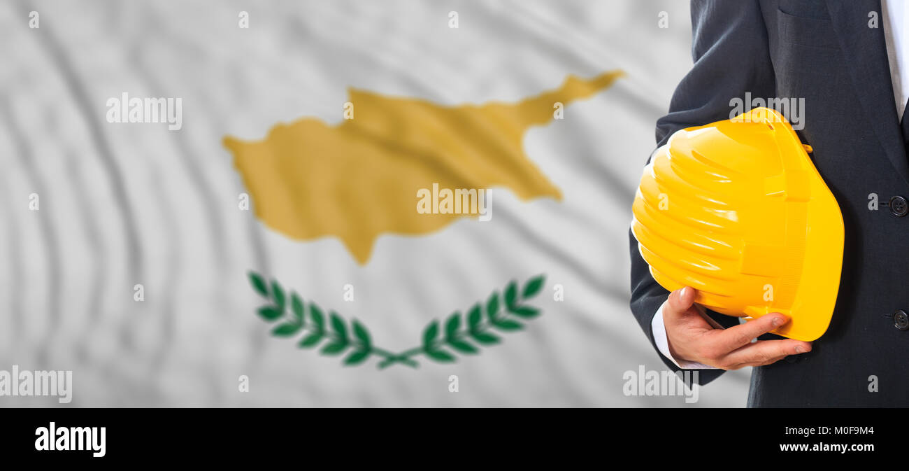 Construction industry in Cyprus. Man holding a yellow hardhat on Cyprus ...