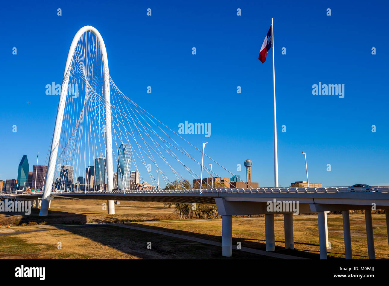 Margaret Hunt Hill Bridge with the Texas flag and Dallas skyline in the ...