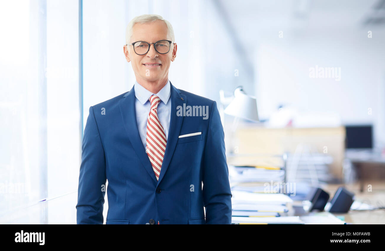 Smiling senior financial advisor businessman wearing suit and eyewear ...