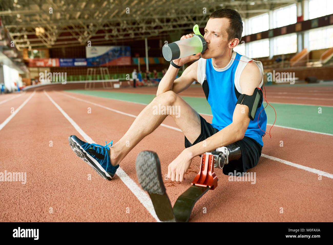 Amputee Sportsman Sitting on Stadium Track Stock Photo - Alamy