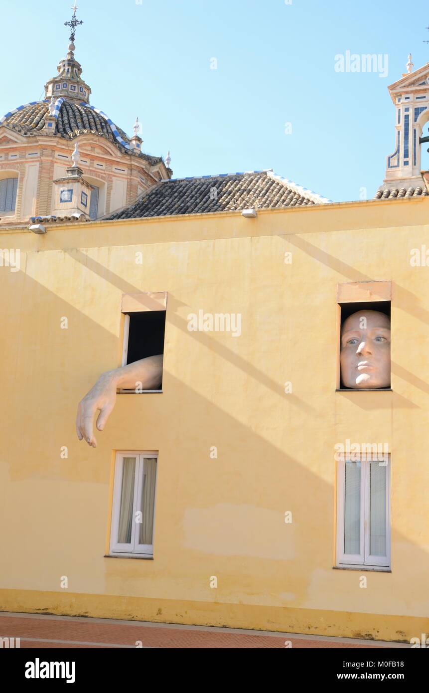 Giant face and arm escaping through windows on wall of the Monastery of ...