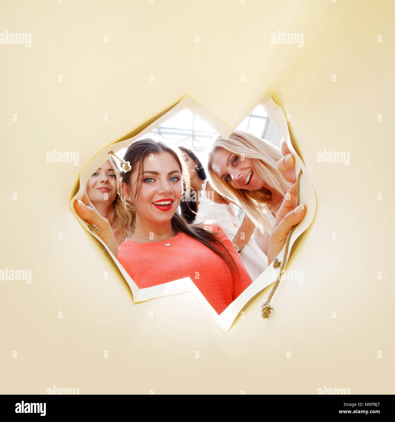 beautiful young women looking inside bag Stock Photo - Alamy