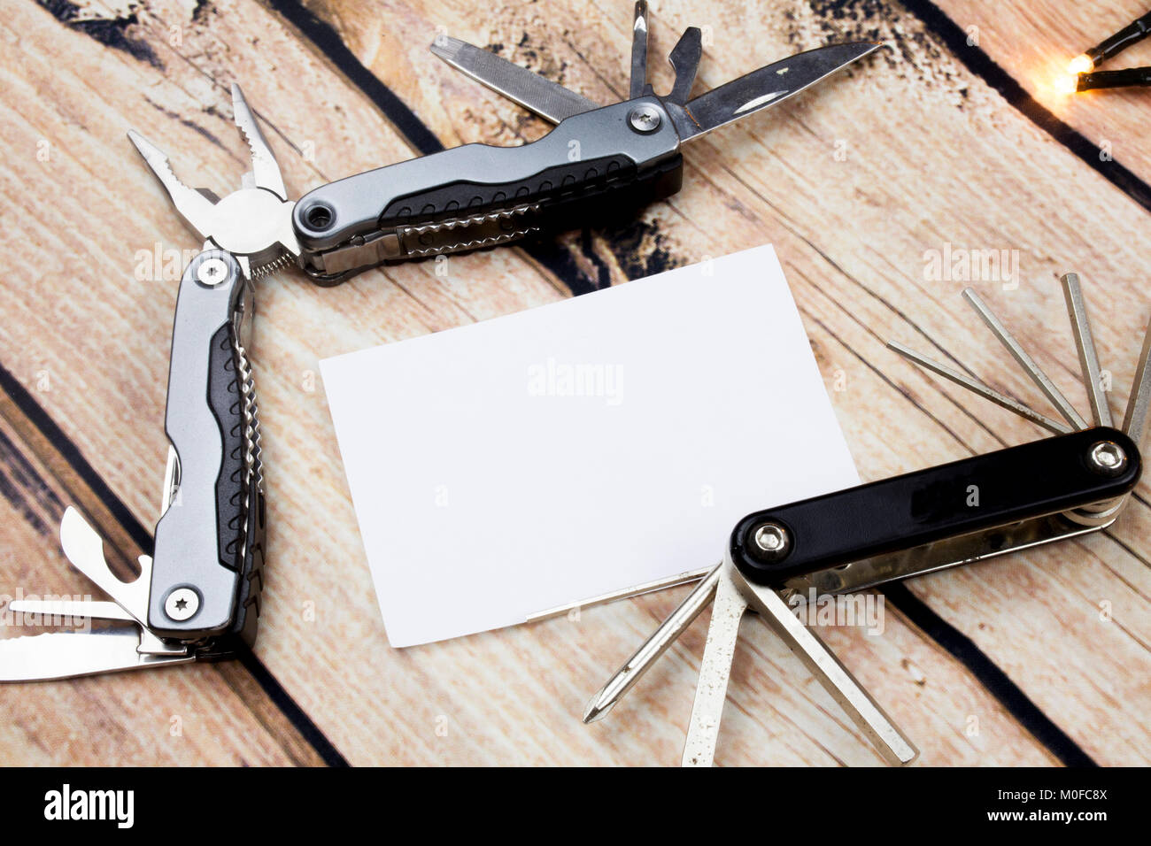 White paper stickers on wooden table. Empty sticky note with lights ...