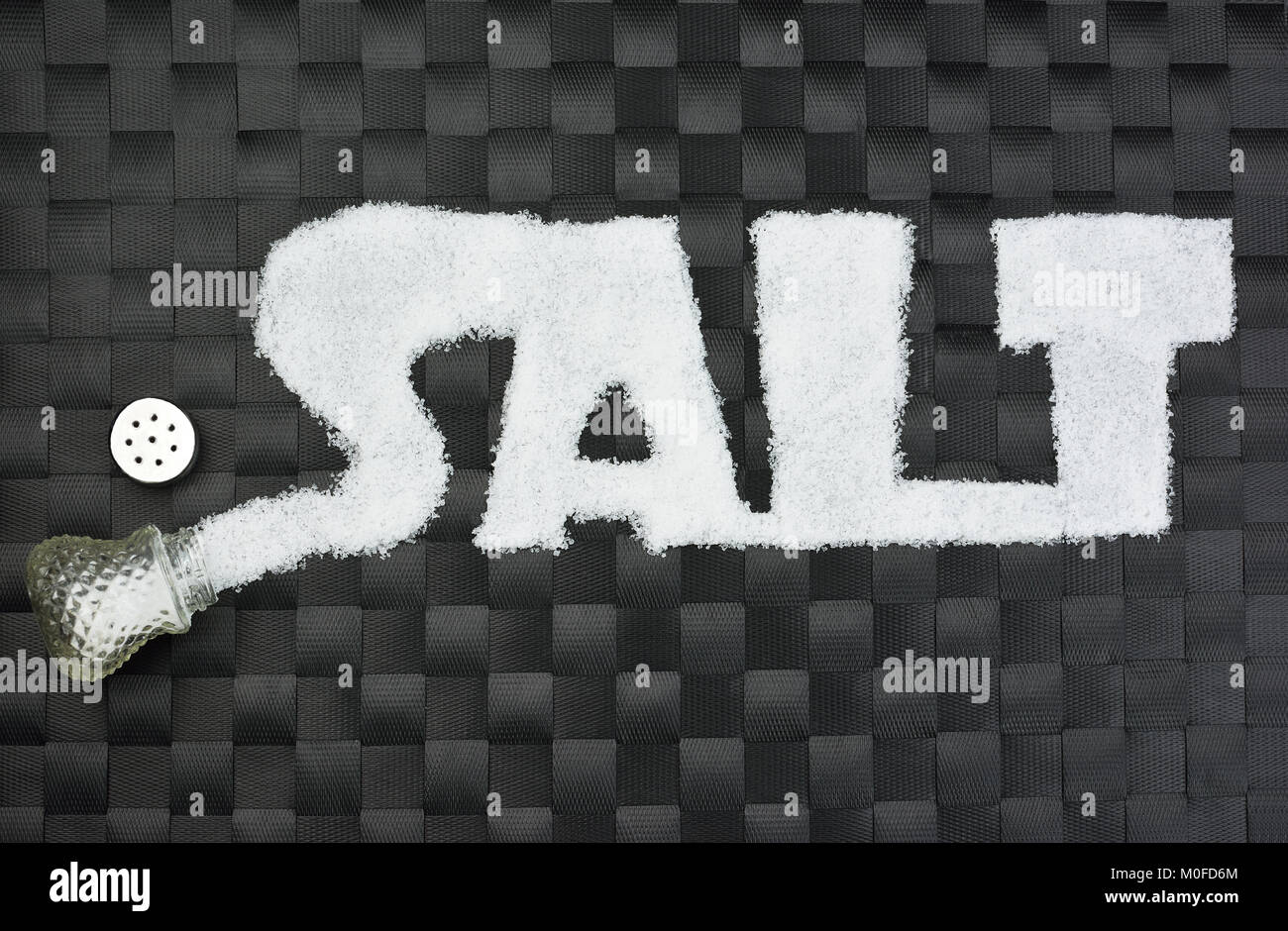 Open saltcellar and word salt written with salt on black background ...