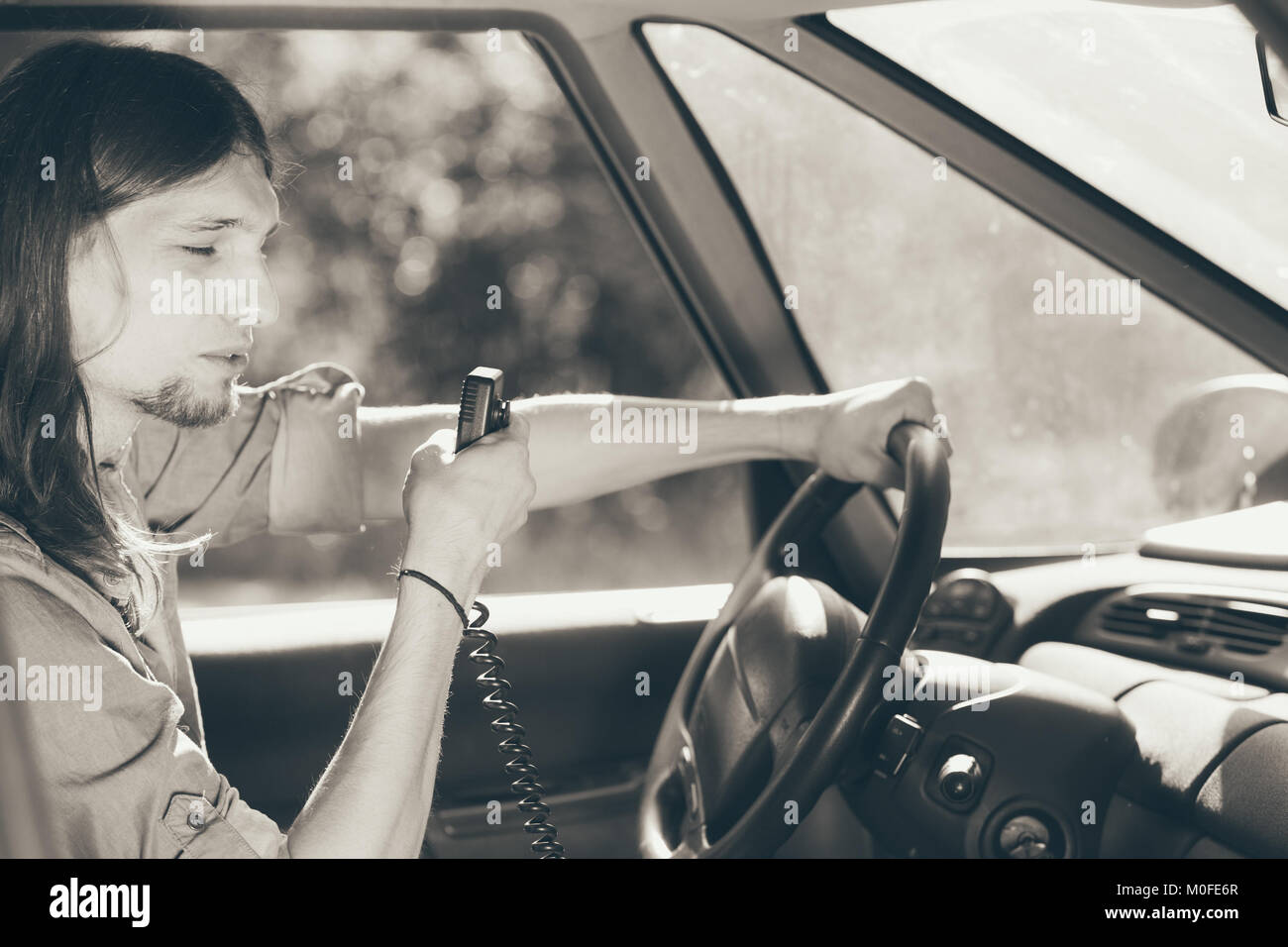 Talking while drive, auto walkie talkie, comunication concept. Young ...