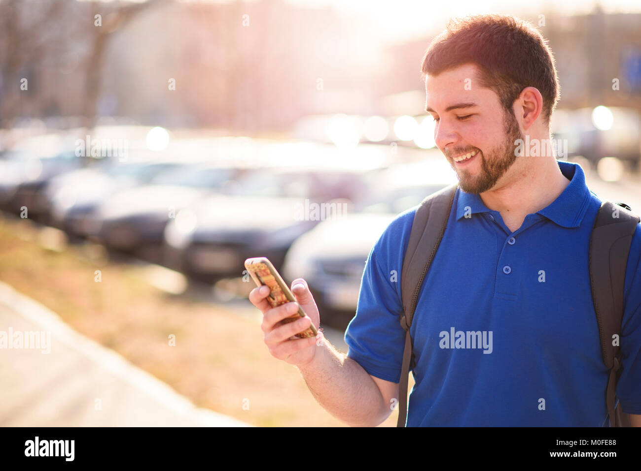 Young man using his phone for directions Stock Photo - Alamy