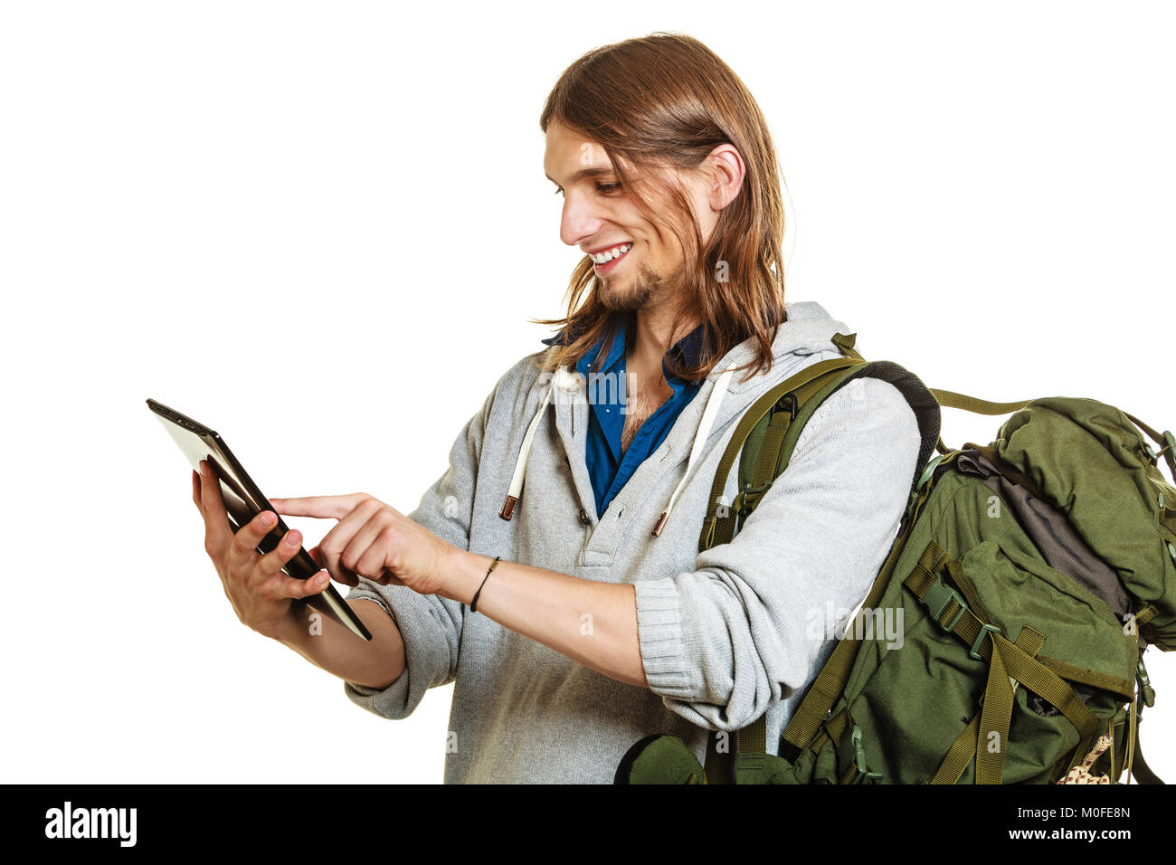 Backpacker man using pc computer tablet browsing surfing the internet ...