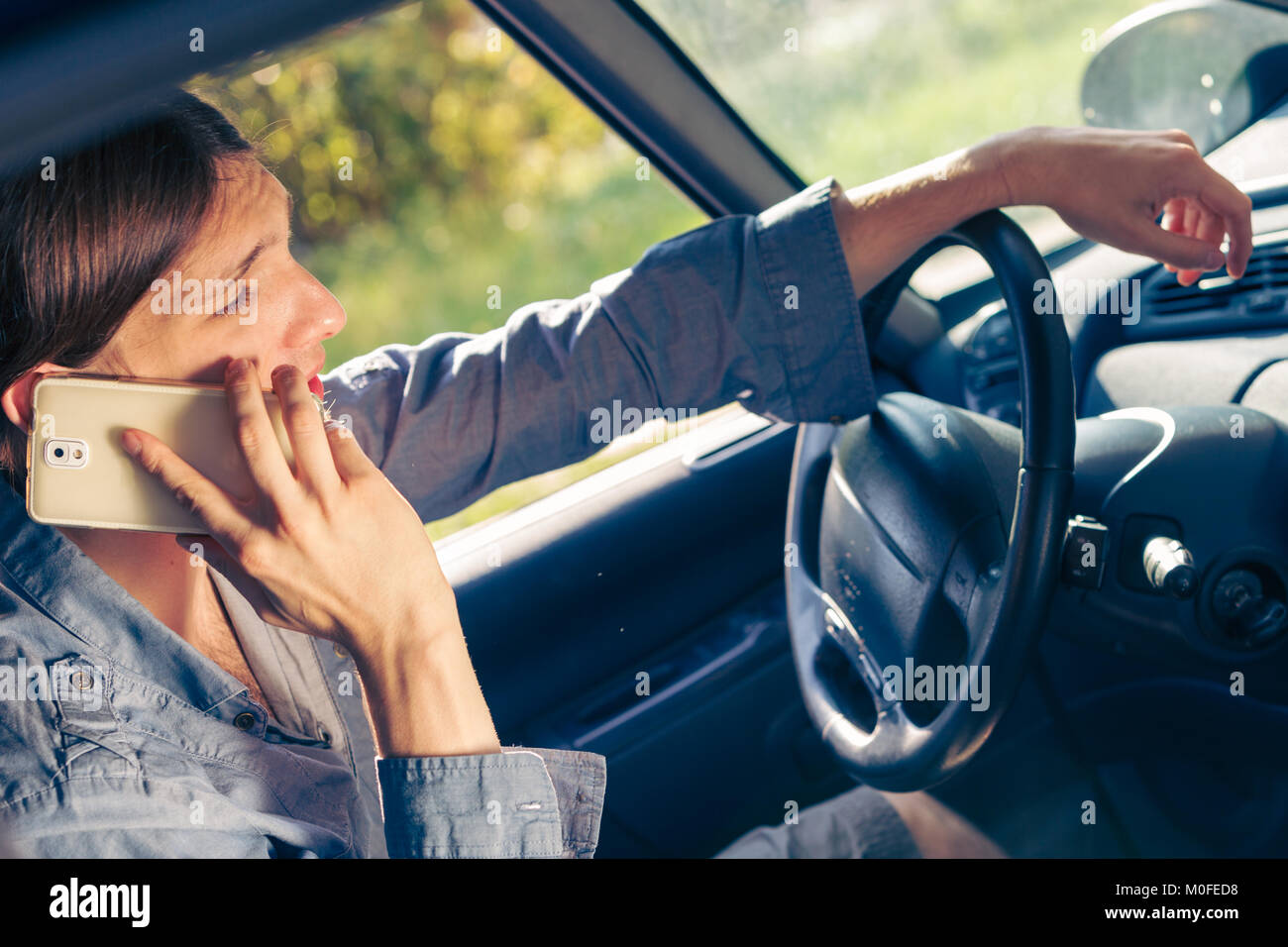 Talking while drive, danger fresh driver concept. Young man driving car ...