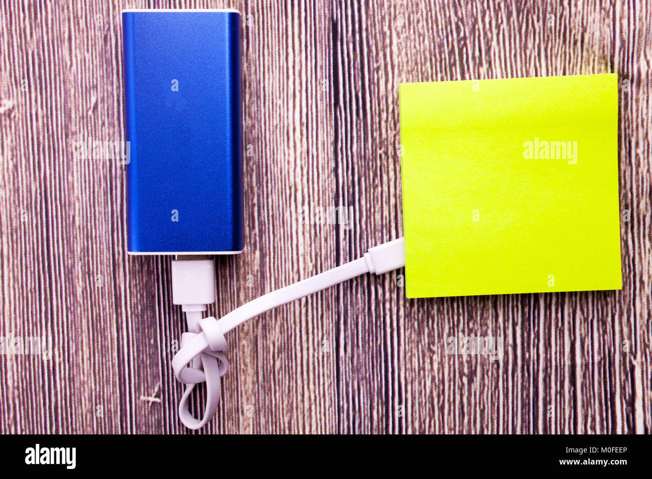 sticky note paper charging with energy bank. Depth of field on Power ...