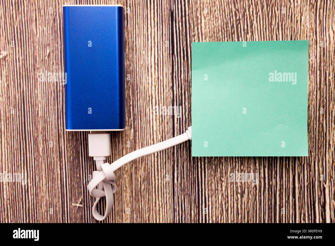 sticky note paper charging with energy bank. Depth of field on Power ...