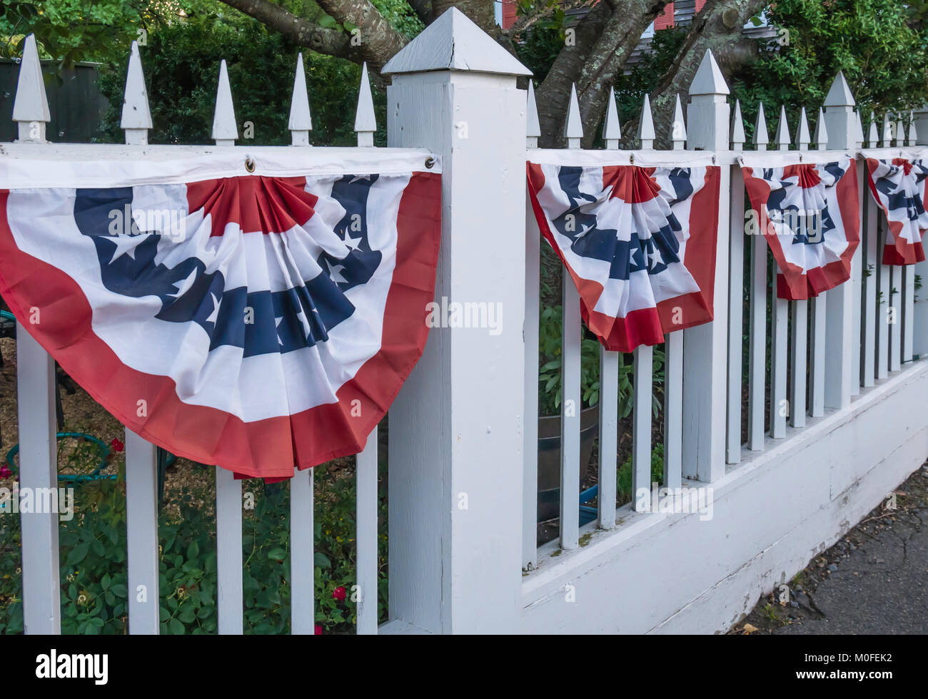 Patriotic red white and blue flag bunting on a white fence Stock Photo ...