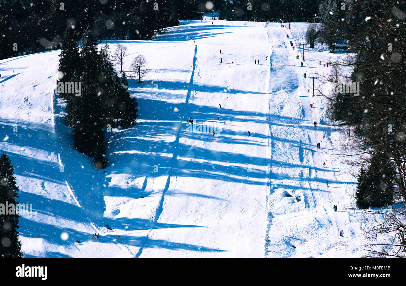 Piste ski tracks on snowy and sunny mountain side Stock Photo - Alamy