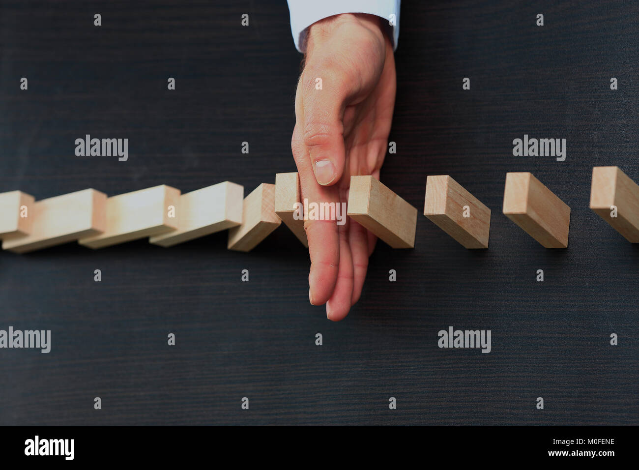 male hand placing wooden block on a tower. planing and strategy concept ...
