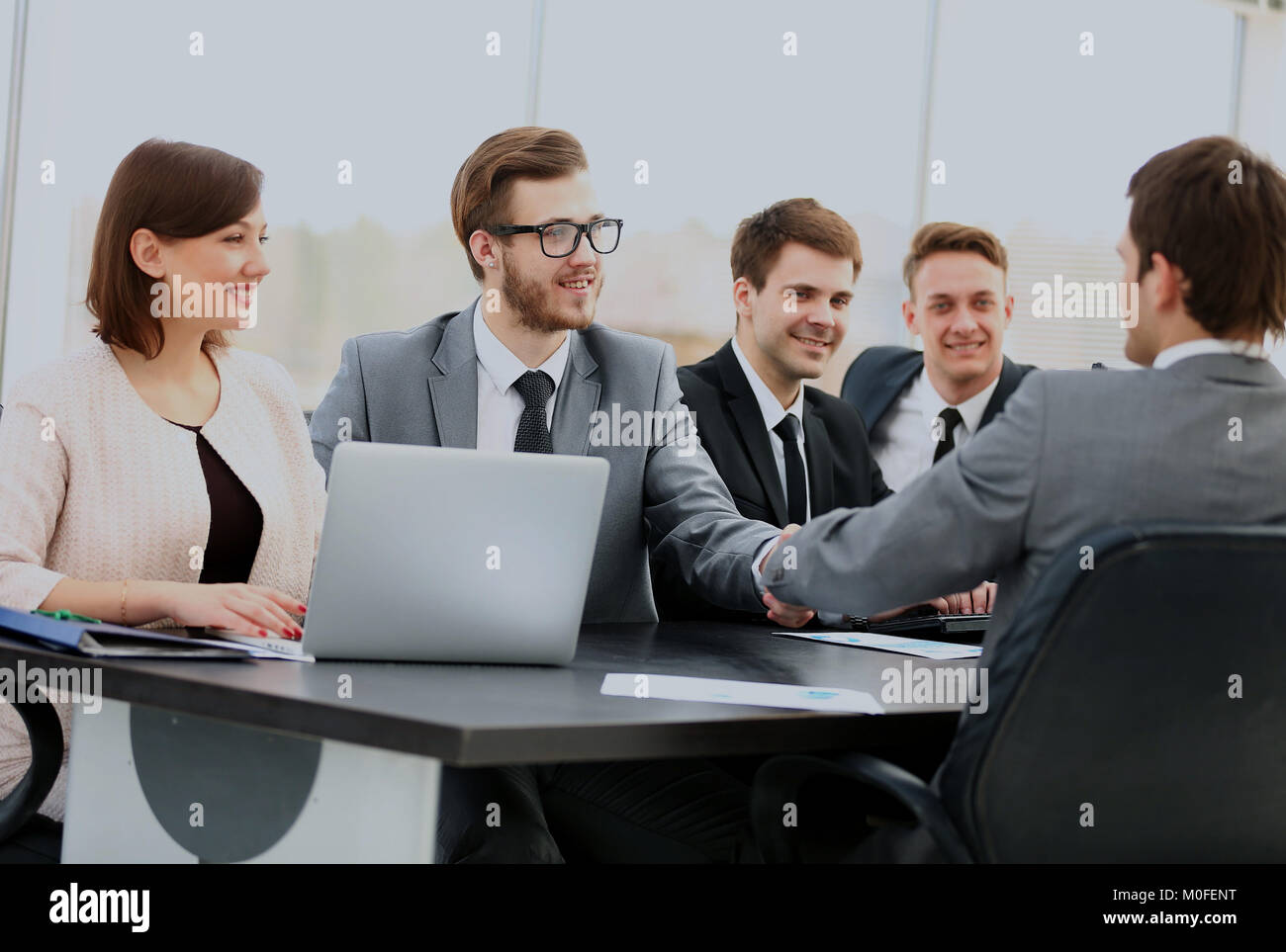 Two businessmen handshaking colleagues hi-res stock photography and images - Alamy