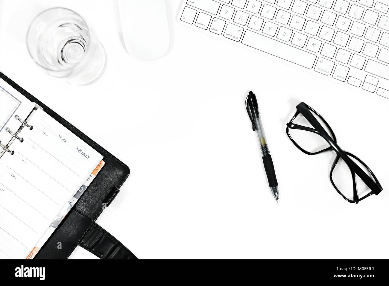 White office desk table with open diary,computer keyboard,computer ...