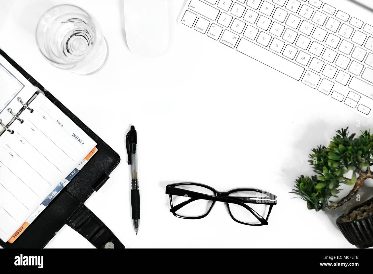 White office desk table with open diary,computer keyboard,computer ...