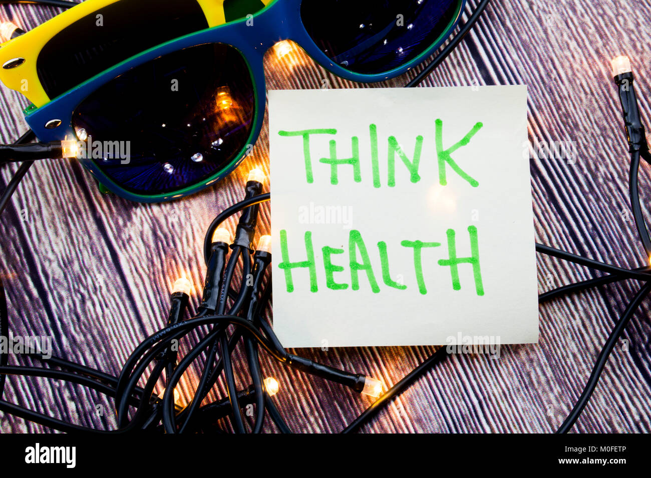 Think Health Sticky note paper with sunglasses on a wooden background ...
