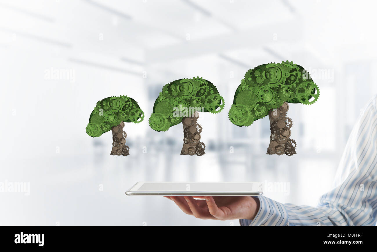 Eco green environment concept presented by tree as working mechanism or ...