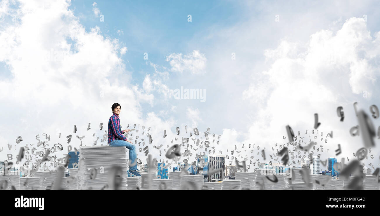 Attractive man sitting on pile of paper documents Stock Photo - Alamy