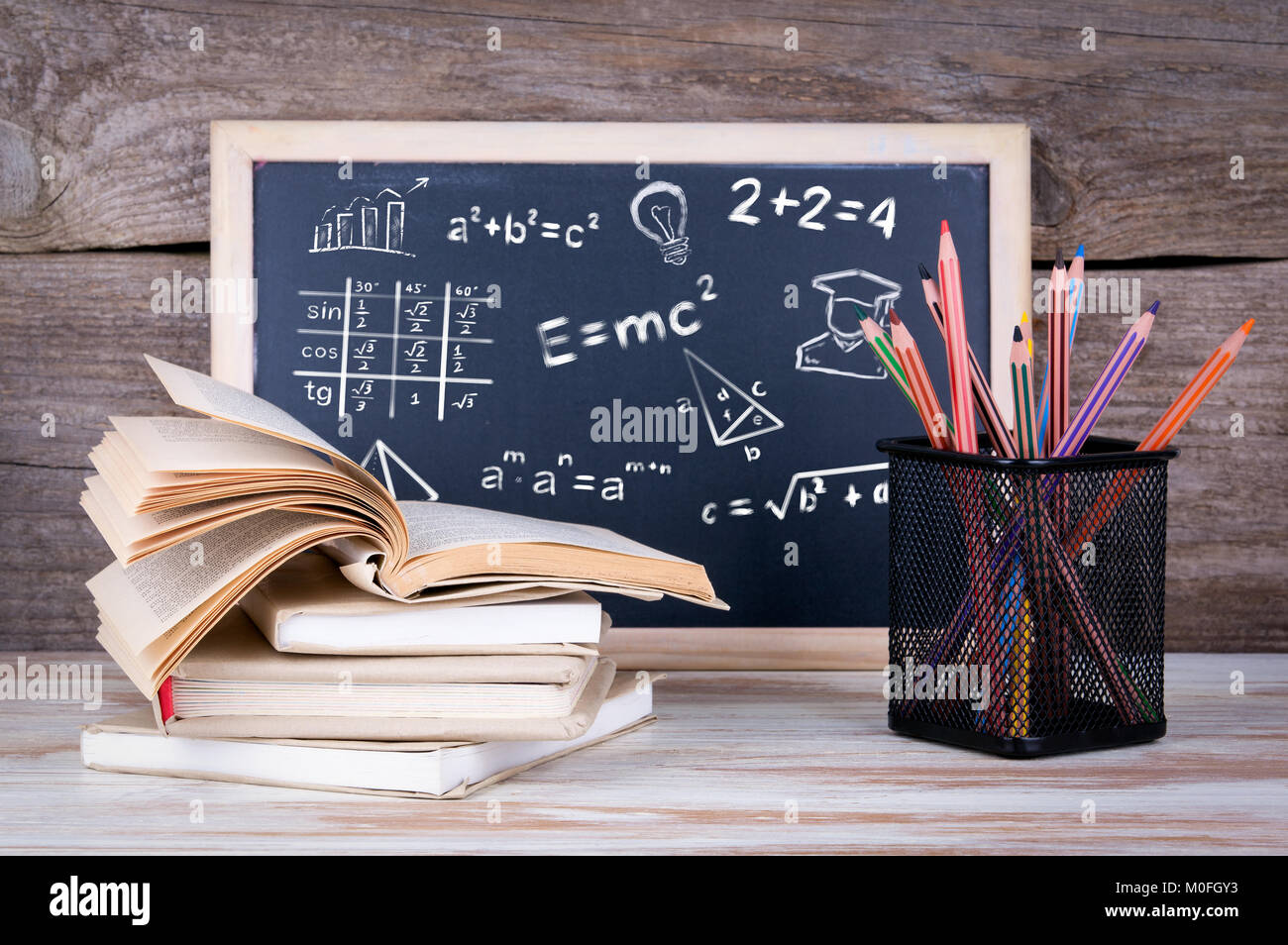 math formulas, education and knowledge concept. Stack of books and ...