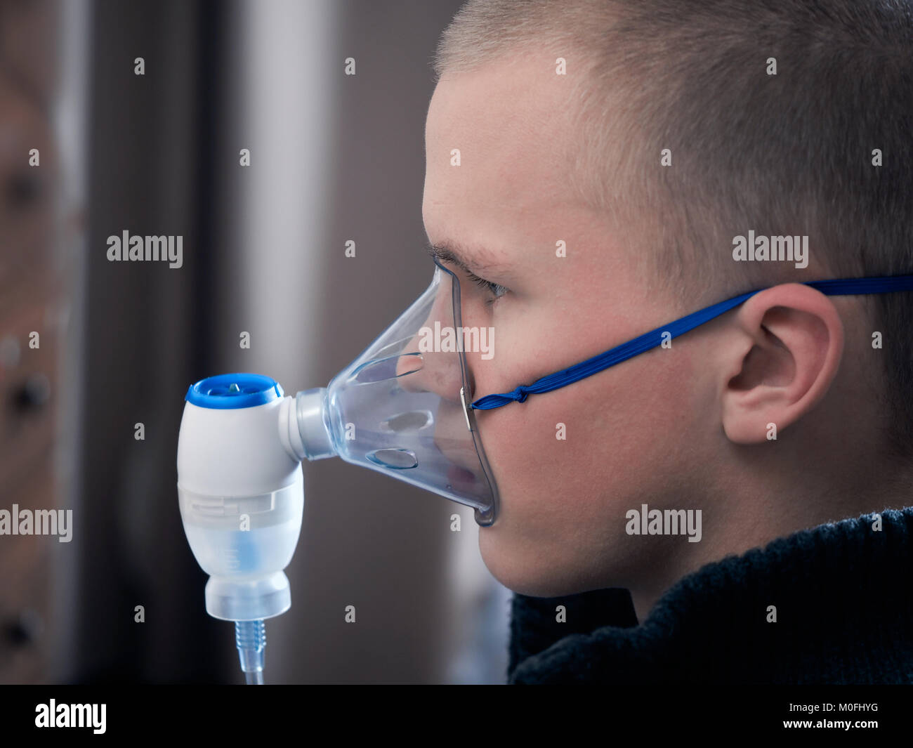 The man inhales the medication through the nebulizer. Portrait Stock ...