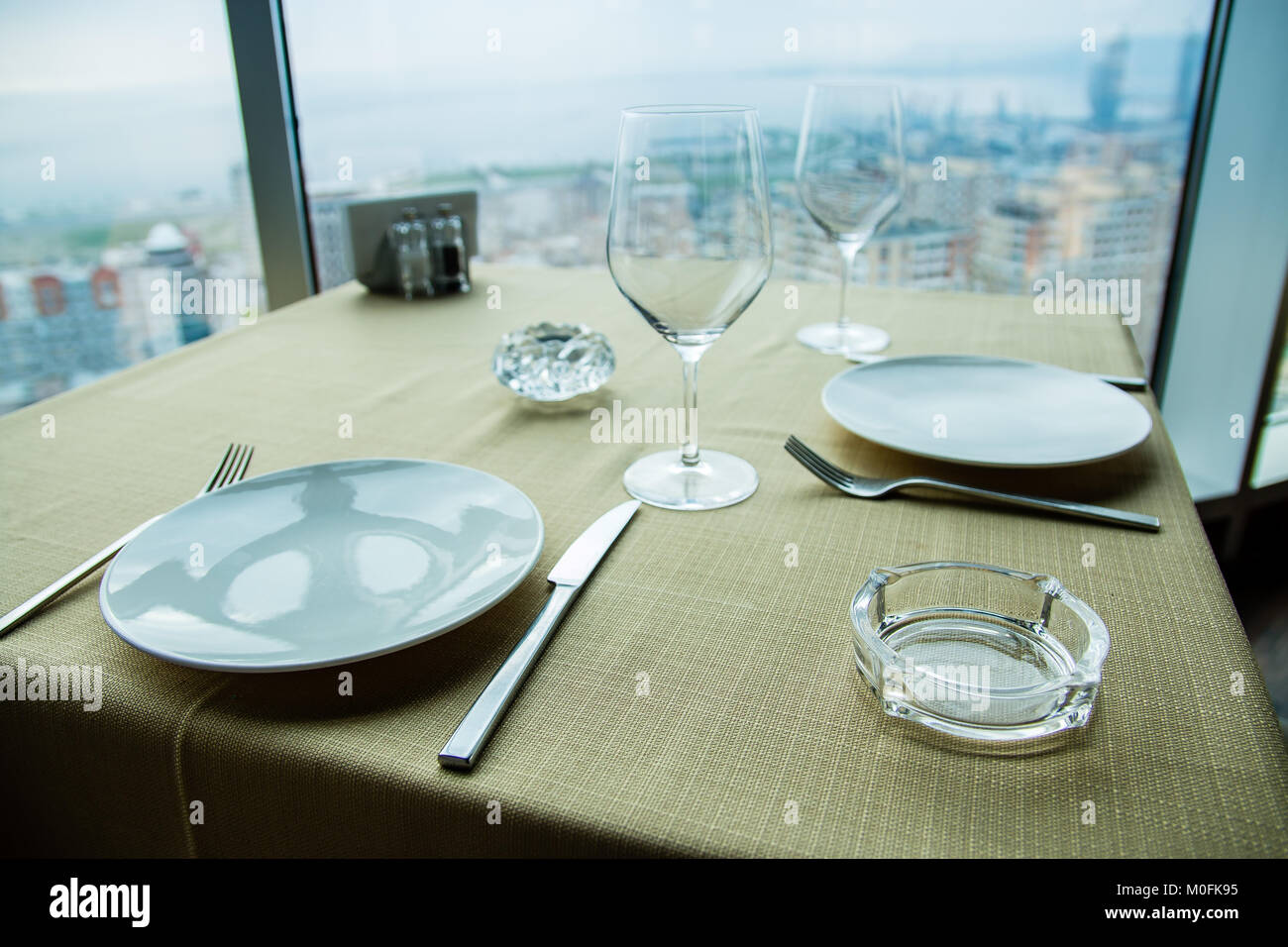 Restaurant empty table for two with large window view Stock Photo - Alamy
