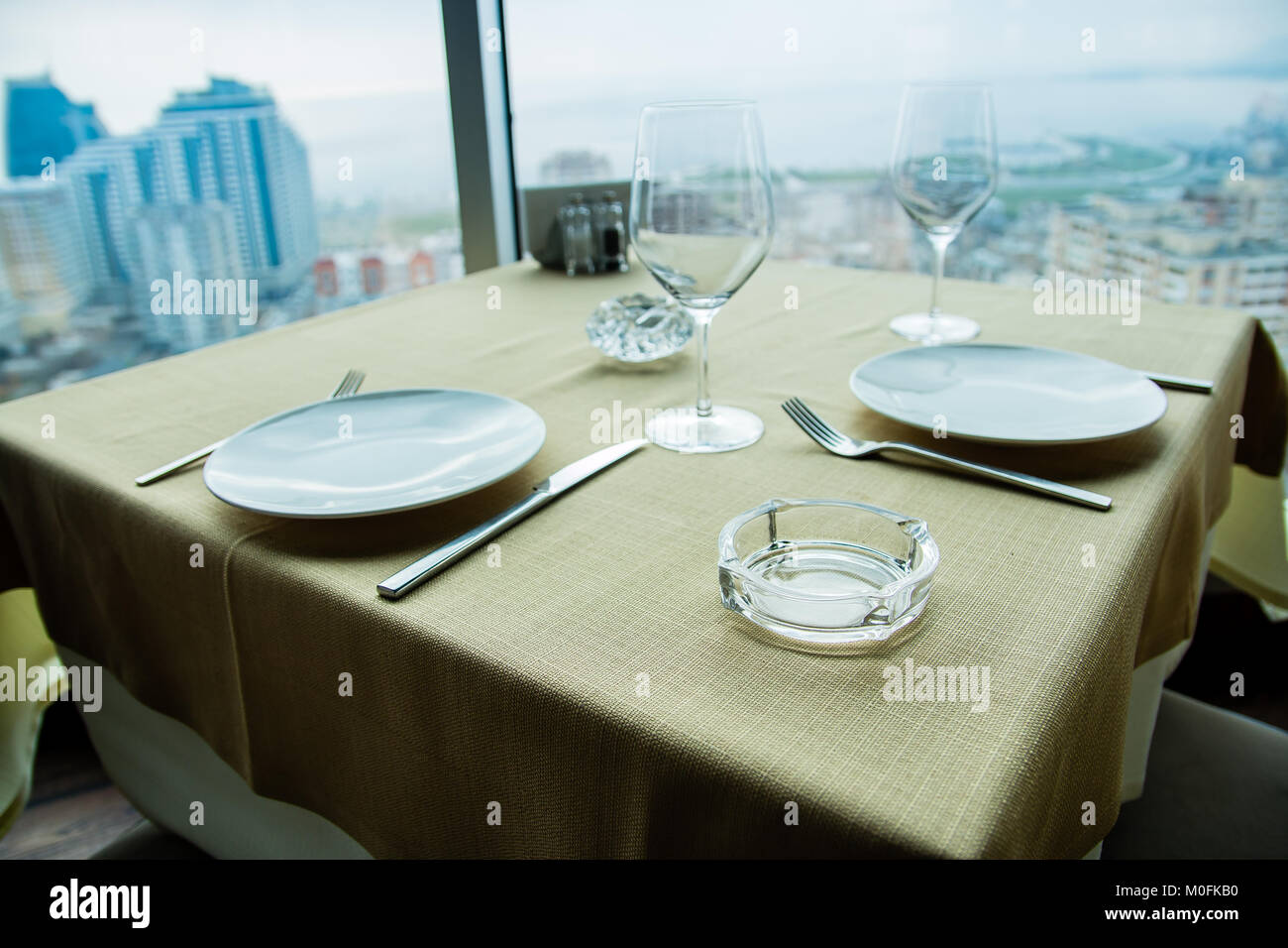 Restaurant empty table for two with large window view Stock Photo - Alamy