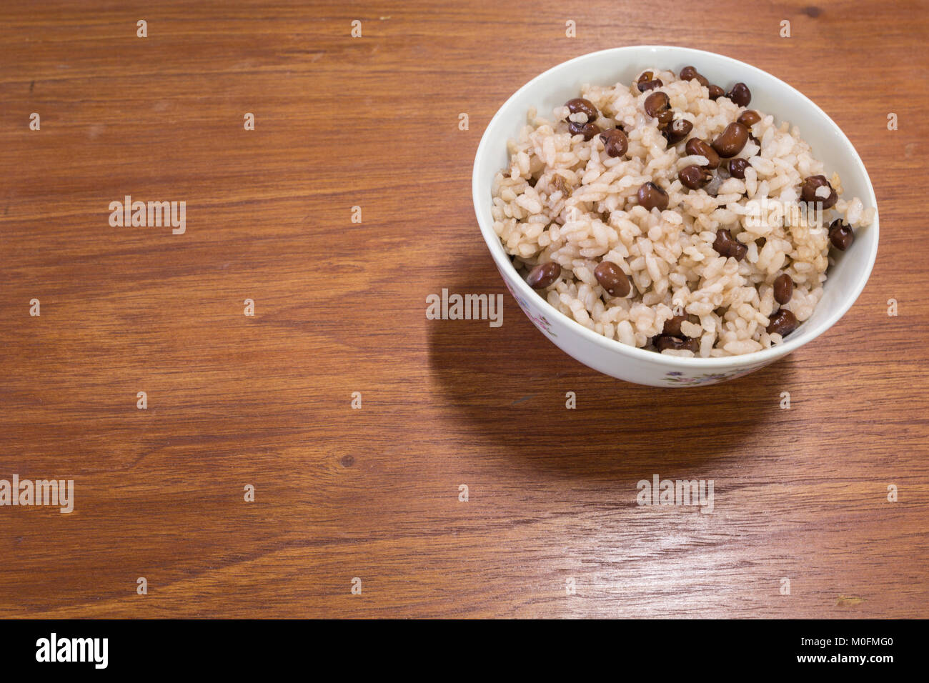 Cooked red beans and Japanese rice in white bowl, centre right, on ...