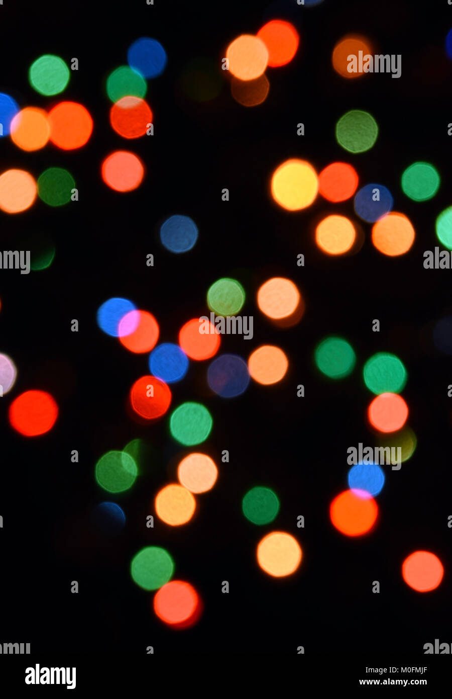 Bright circles of defocused color light on black background Stock Photo ...