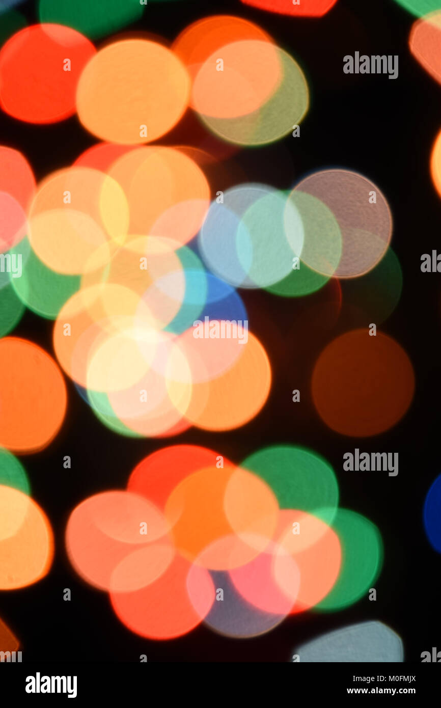 Bright circles of defocused color light on black background Stock Photo ...