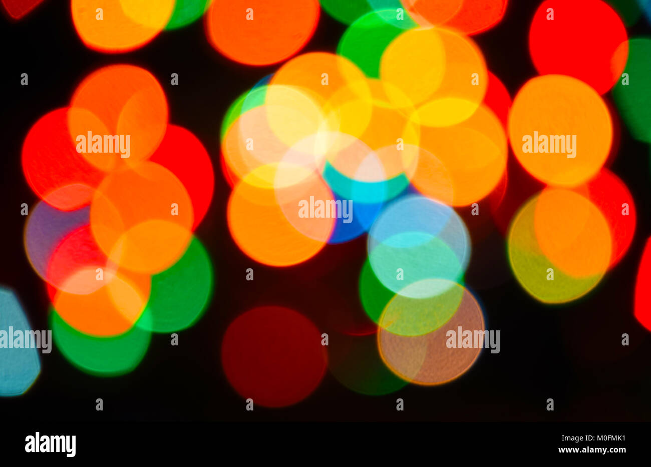 Bright circles of defocused color light on black background Stock Photo ...