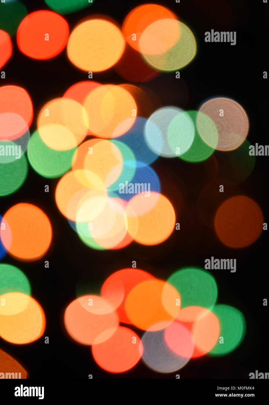 Bright circles of defocused color light on black background Stock Photo ...