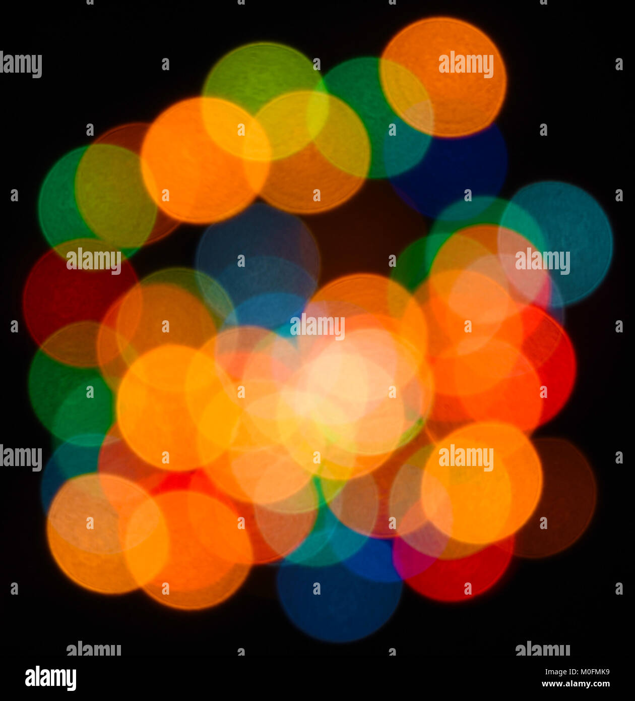 Bright circles of defocused color light on black background Stock Photo ...