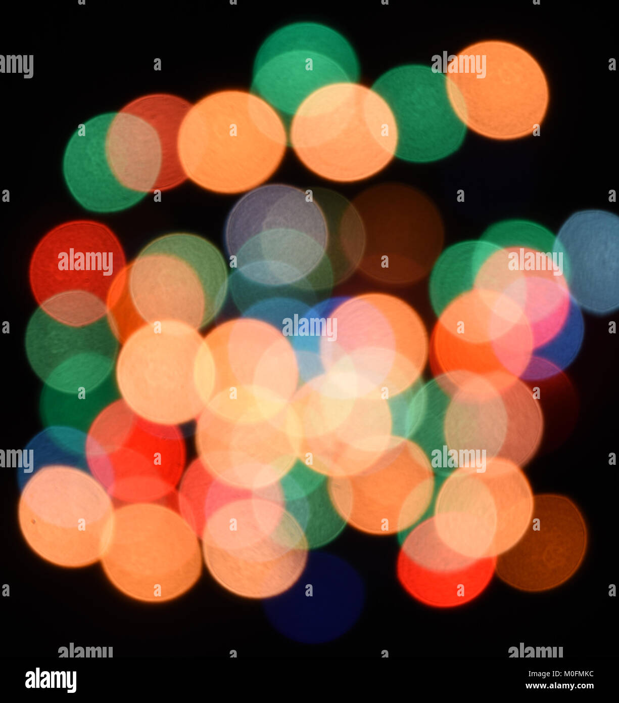 Bright circles of defocused color light on black background Stock Photo ...