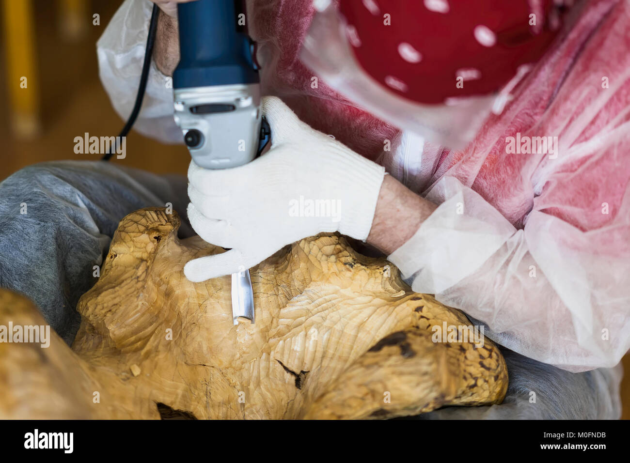 Woodcarver with glasses carving from natural precious wood, art object ...
